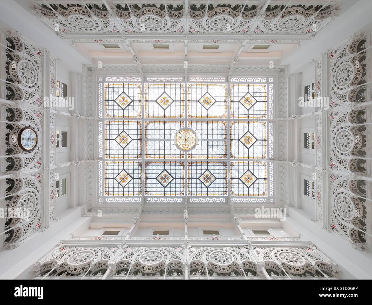 Directly from below view of large skylight with stained glass decor on ...