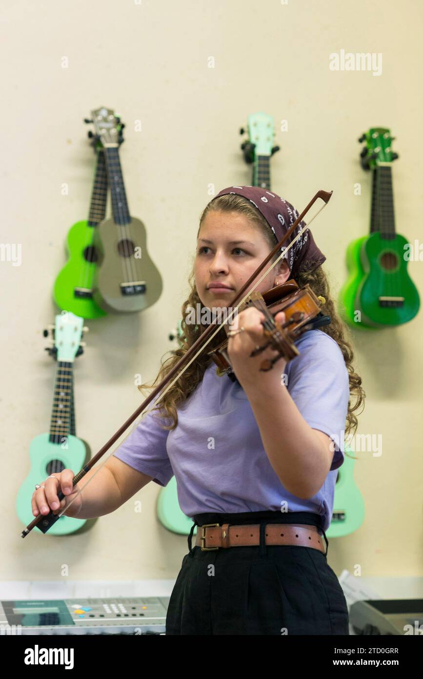Students in a classroom learning how to play musical instruments Stock ...