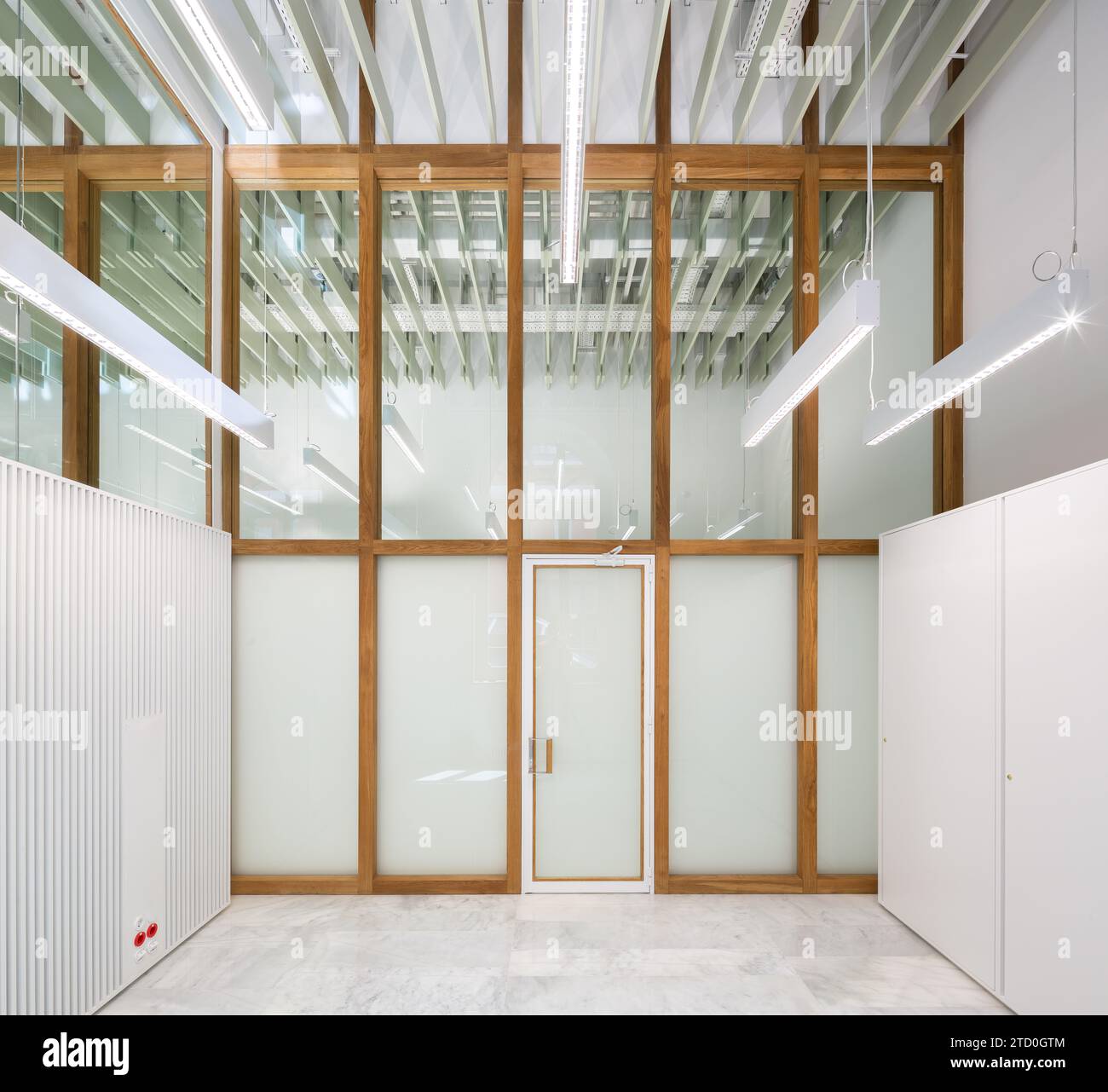 Illuminated interior of modern university library with glass and wooden ...