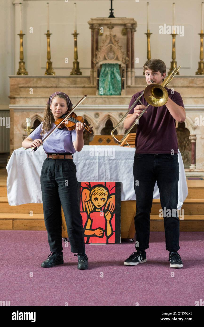 Students in a classroom learning how to play musical instruments Stock ...