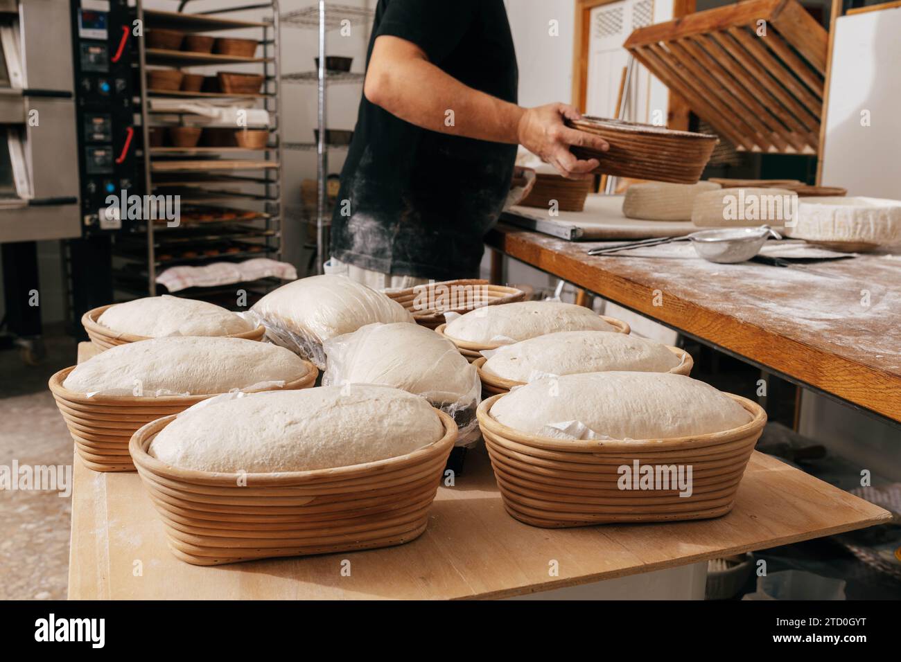 Side view of focused anonymous male professional baker covering ...