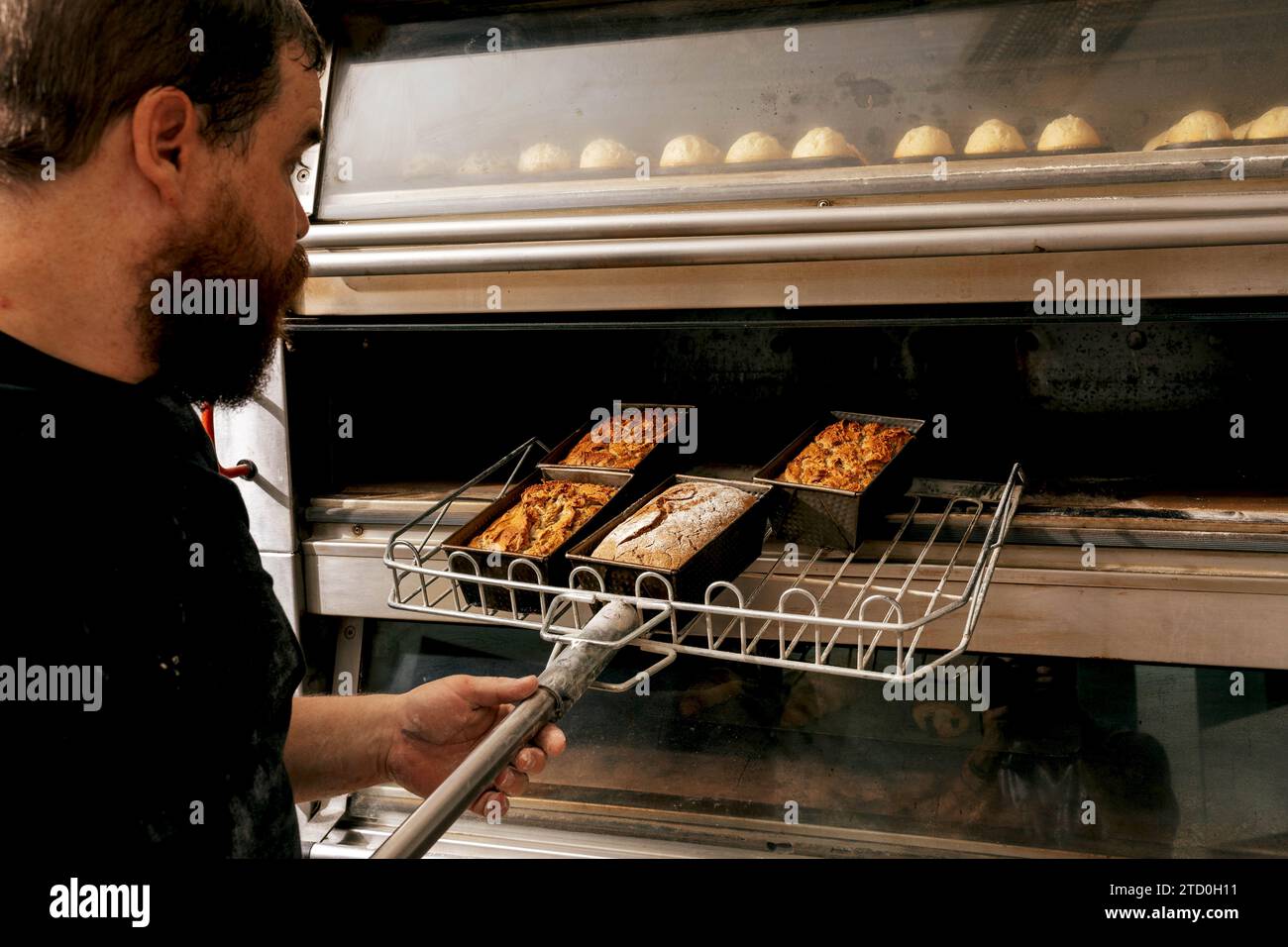 Man taking baked bread from hi-res stock photography and images - Alamy