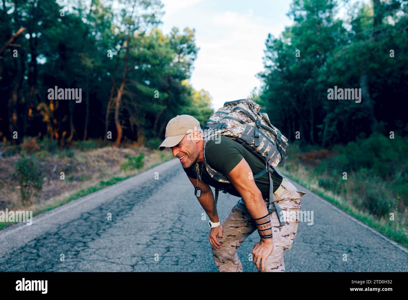 Tired mature special force marine soldier wearing uniform and backpack ...