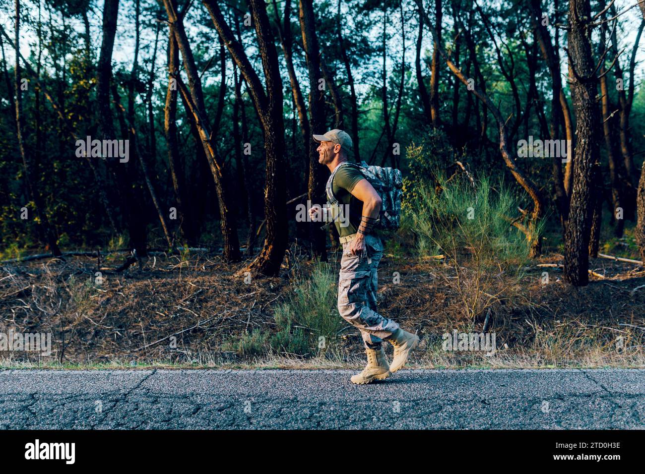Full body side view of happy middle aged commando wearing uniform and ...