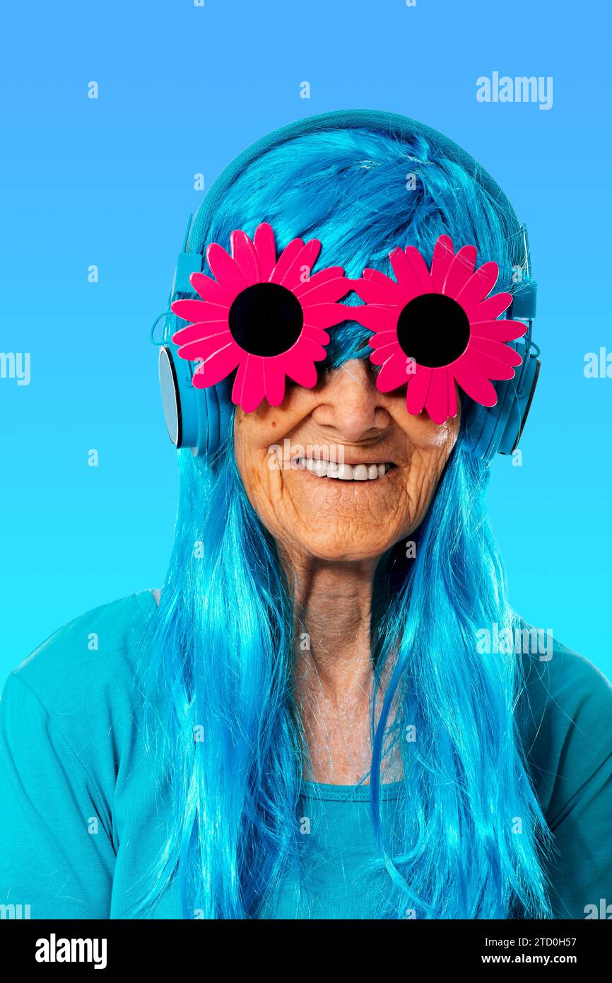 Portrait of happy elderly female with wrinkles and toothy smile looking ...