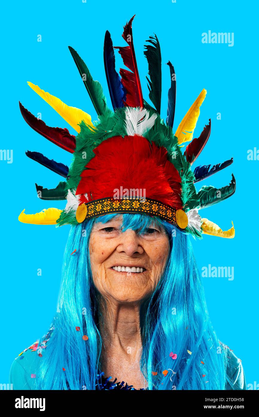 Portrait of smiling senior lady blue in wig with confetti wearing ...