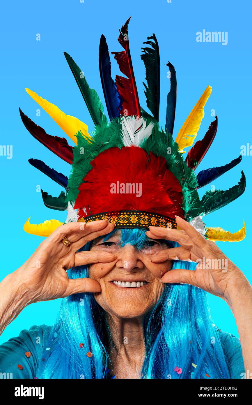 Portrait of smiling senior lady blue in wig with confetti wearing ...
