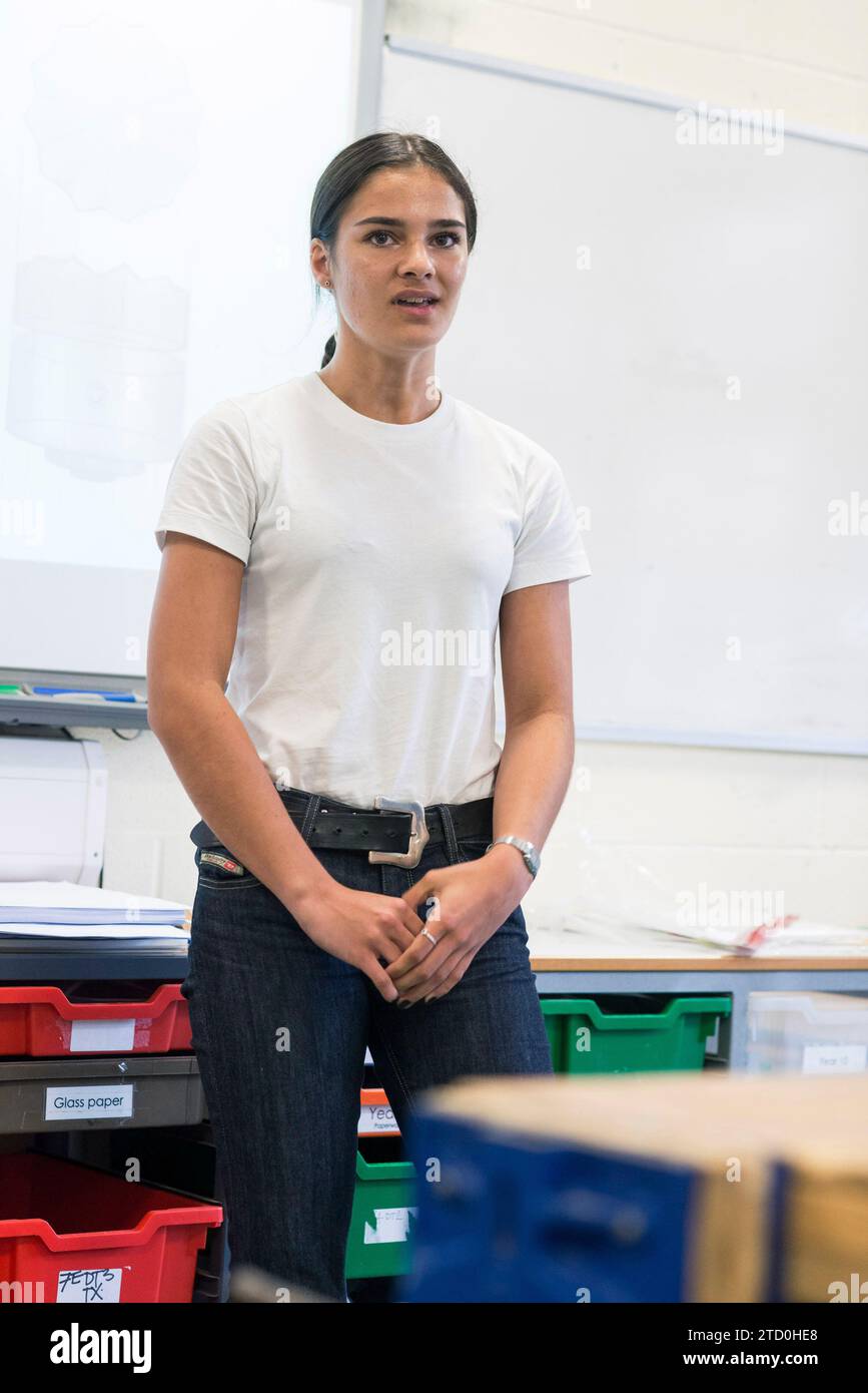 A female A Level student gives a presentation in class about her work ...