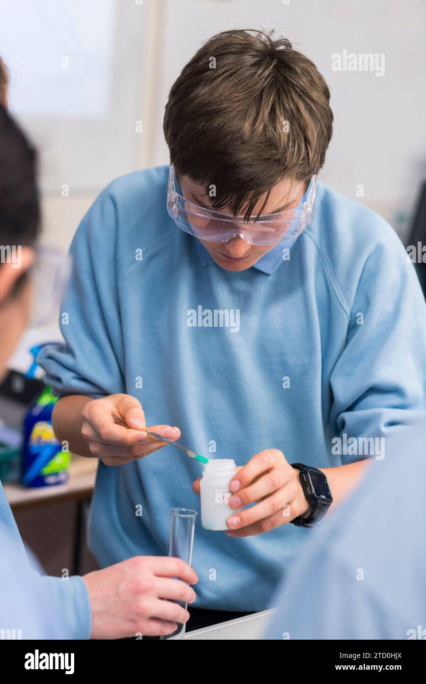 Students in a high school science lab carry out a practical science ...