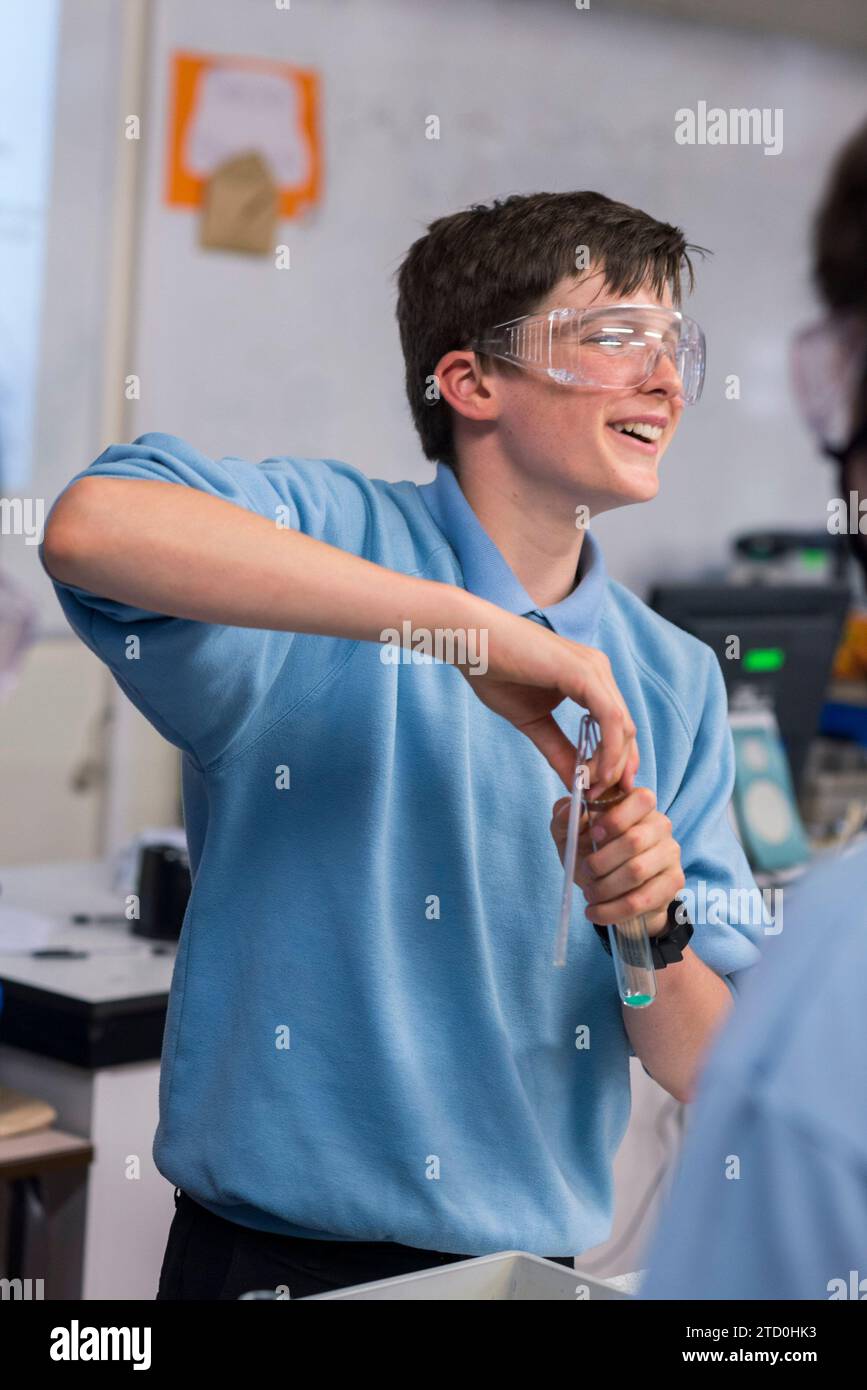 Students in a high school science lab carry out a practical science ...