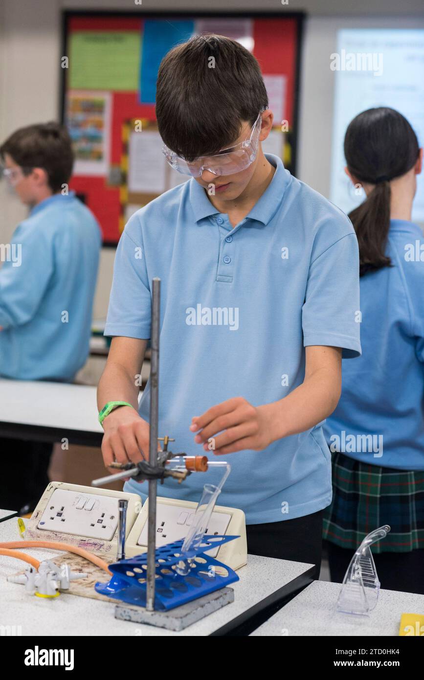 Students in a high school science lab carry out a practical science ...