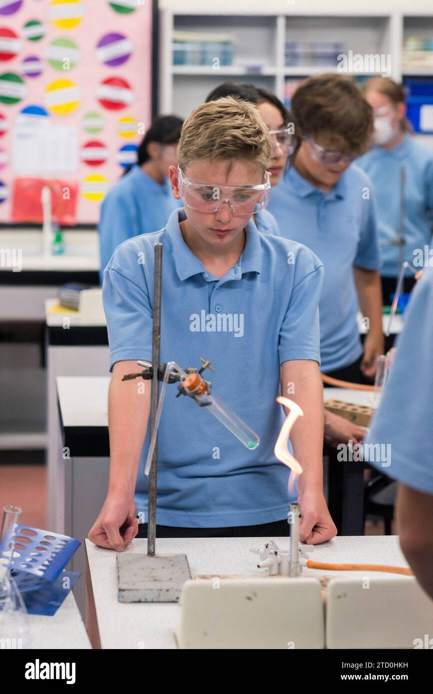 Students in a high school science lab carry out a practical science ...