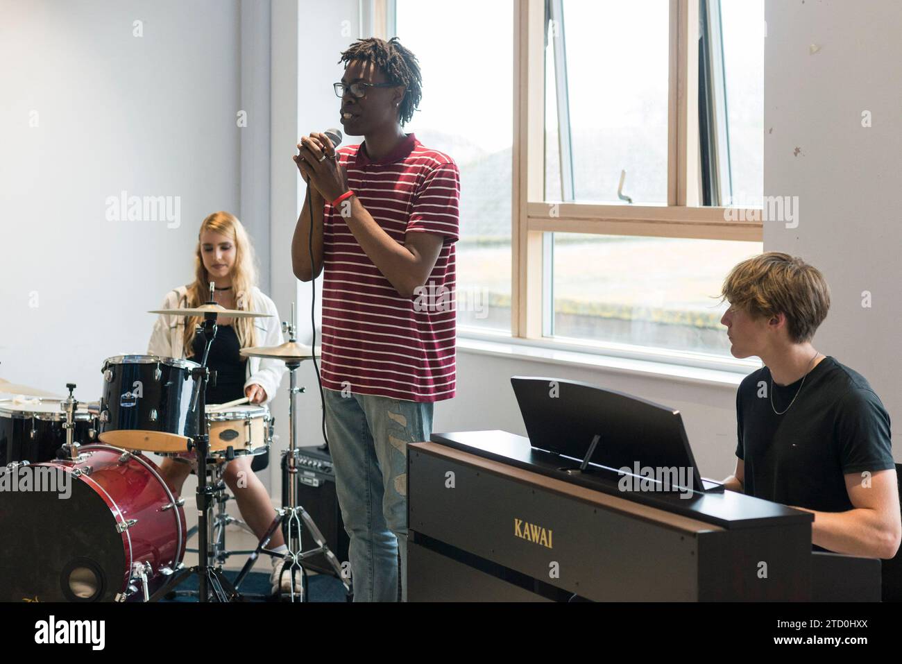 A group of students rehearsal for their bands performance in the music ...