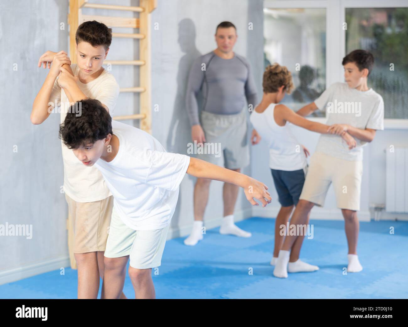 Teenagers practicing painful armlock in sparring at self defence ...