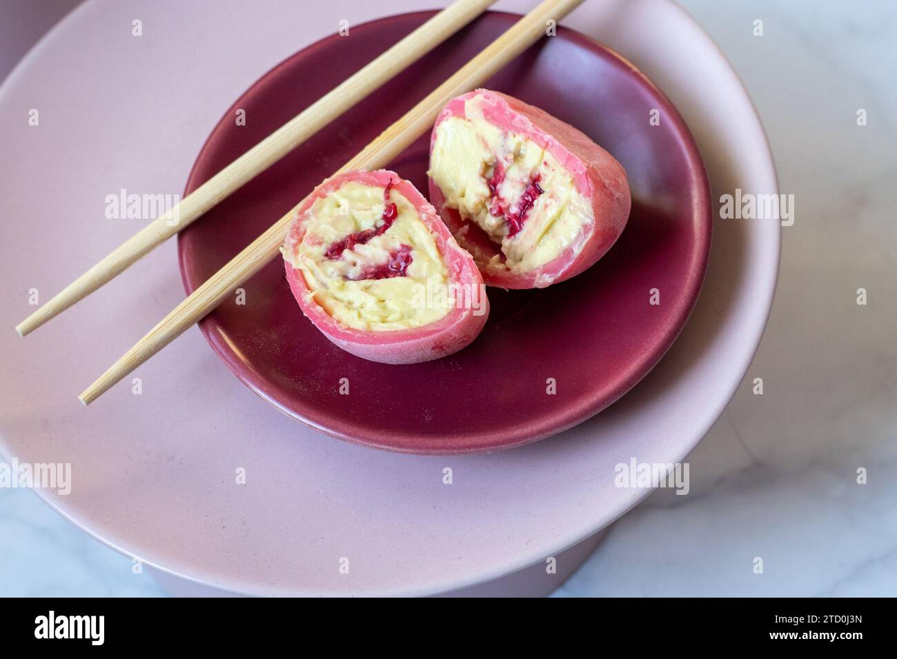 Pink mochi dessert with cream filling and berry. Cut Stock Photo - Alamy