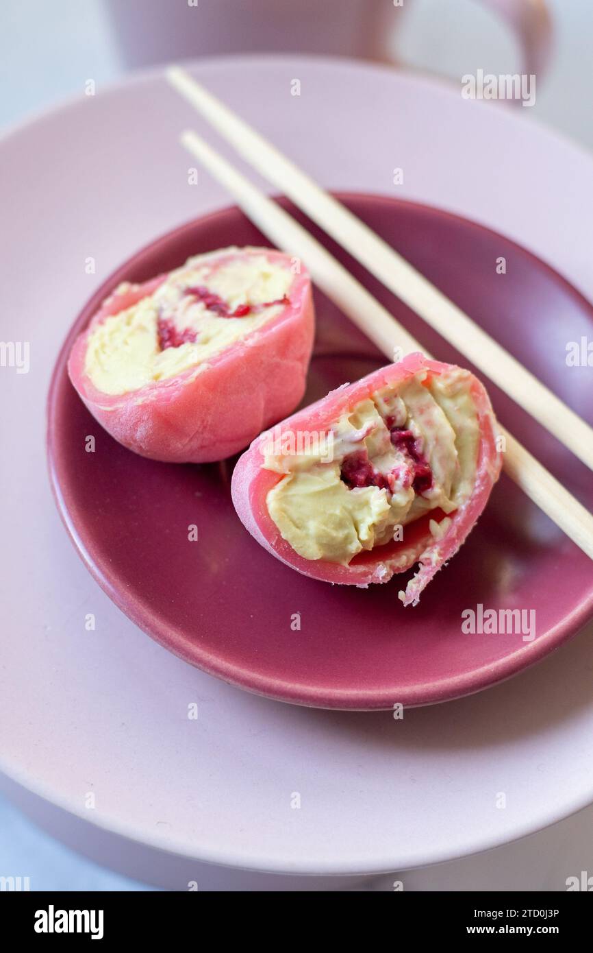 Pink mochi dessert with cream filling and berry. Cut Stock Photo - Alamy