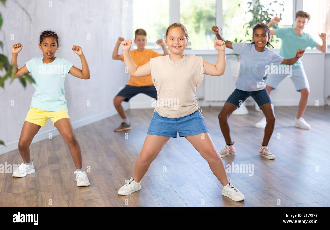 Active preteen children practicing Hip-hop dance in training hall Stock ...