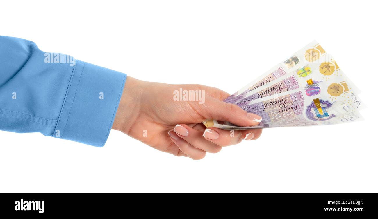 Female hand holding British pounds currency isolated with clipping path ...