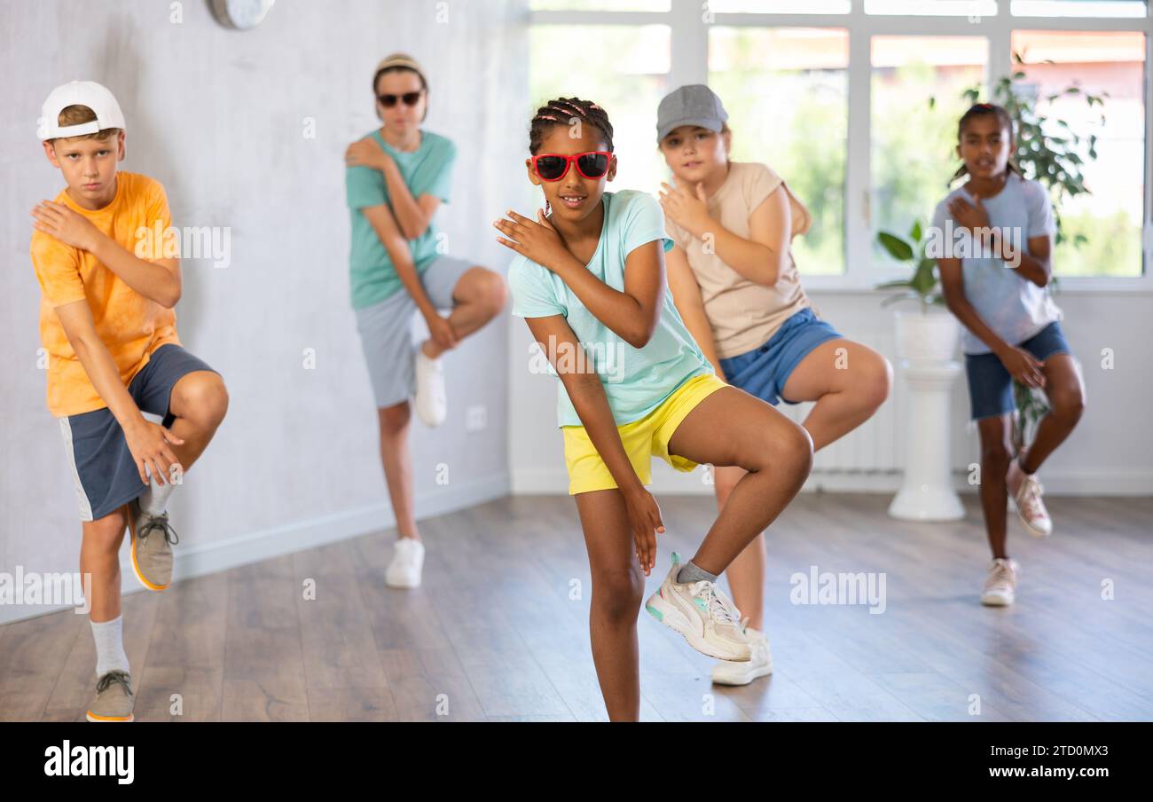 Dark-skinned tween girl krumper posing during workout in dance class ...
