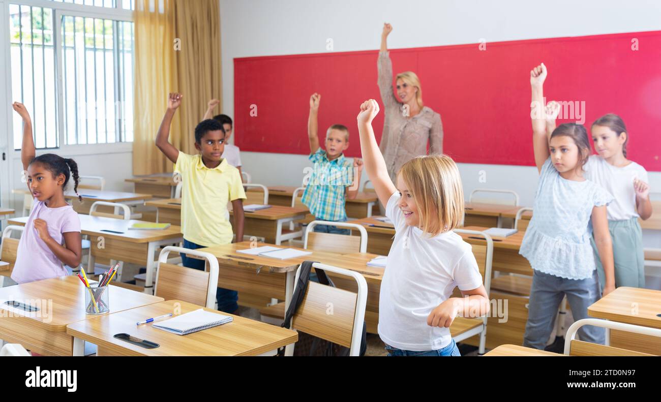 Gymnastics in classroom in elementary school Stock Photo - Alamy