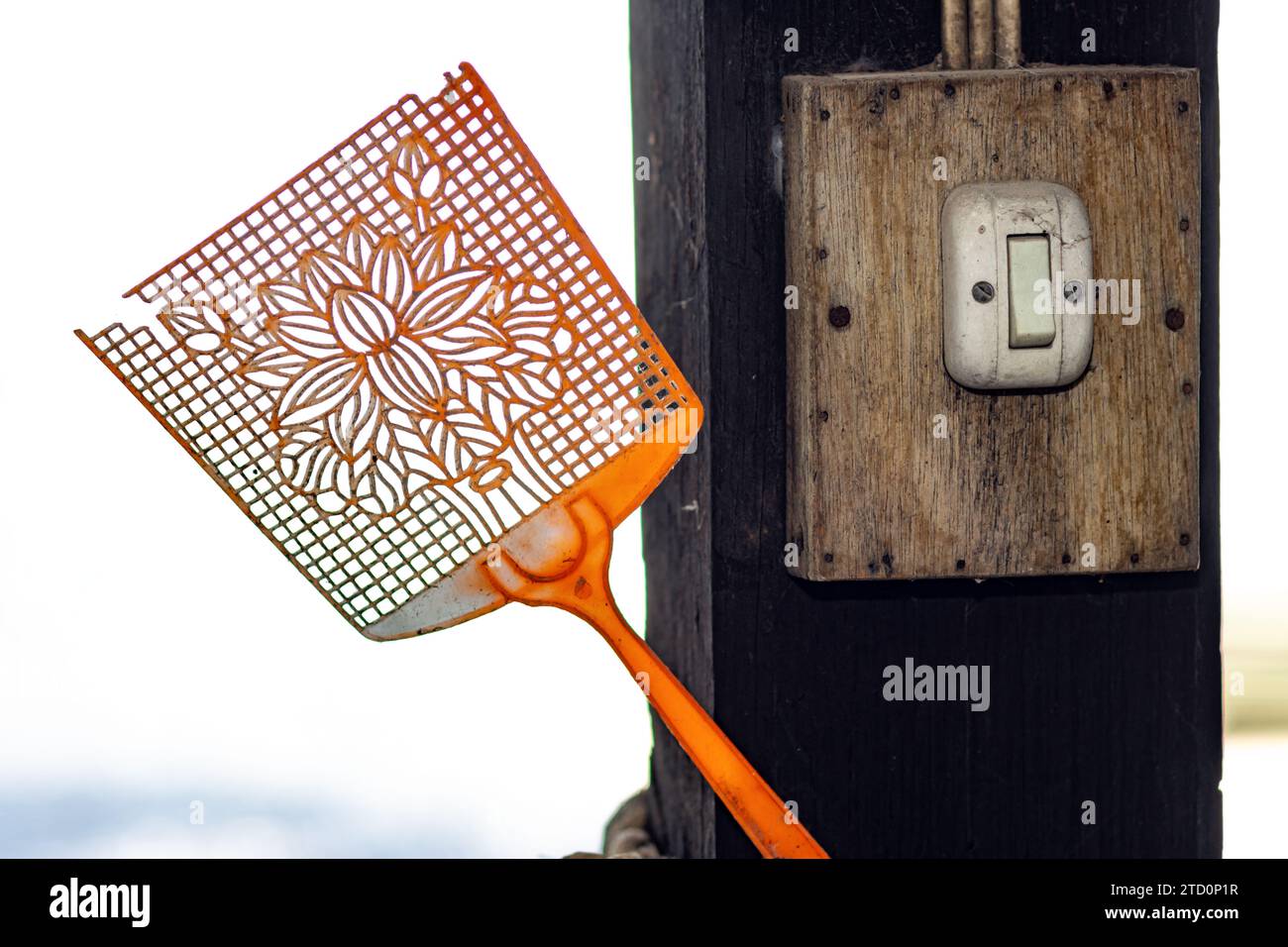 An old fly swatter tied to a beam with a light switch in the yard Stock ...