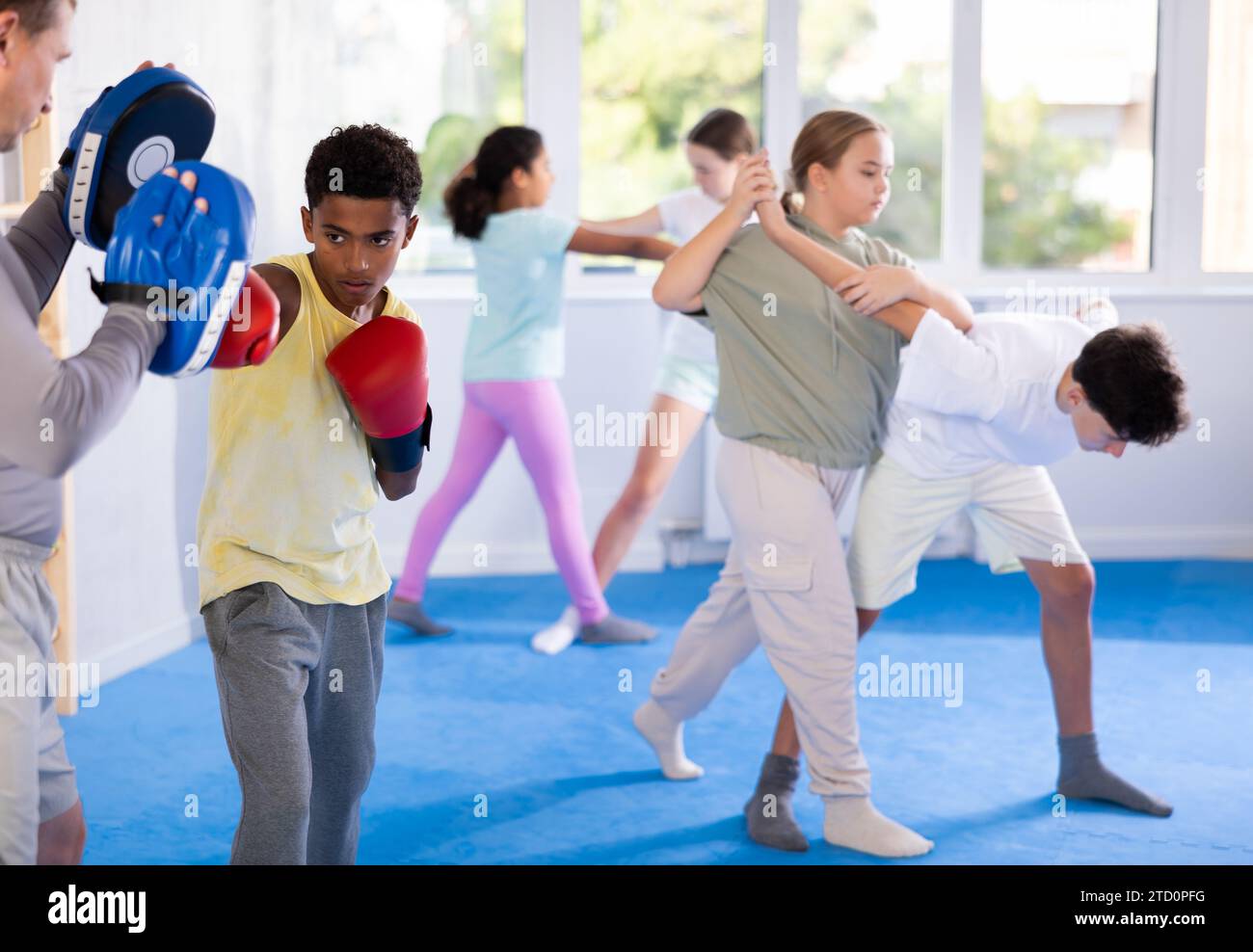 Coach and boy training boxing technique Stock Photo - Alamy