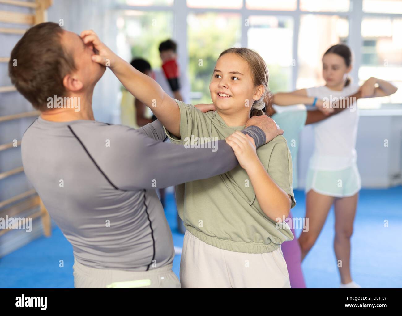 Teenage girl using painful technique to eyes in mock bout with ...