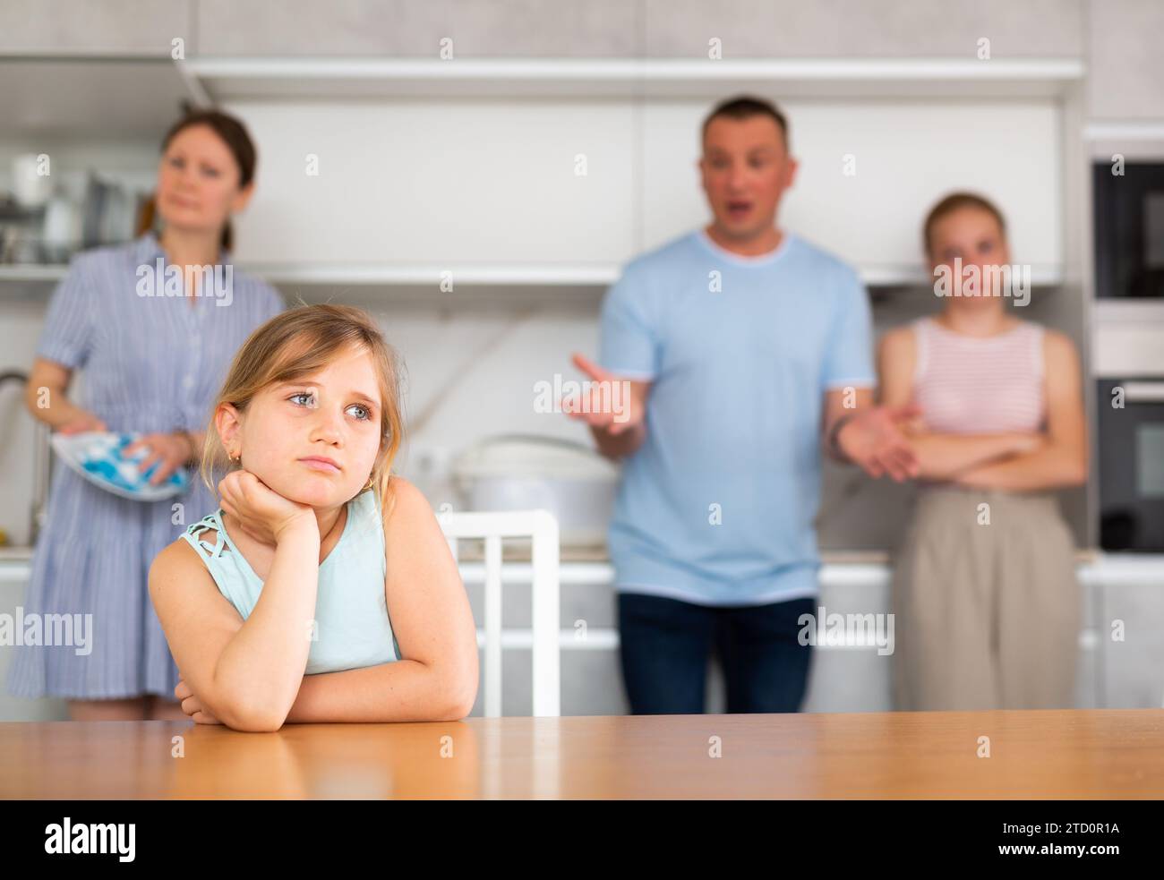 Frustrated tween girl listening to disgruntled parents reprimand Stock ...