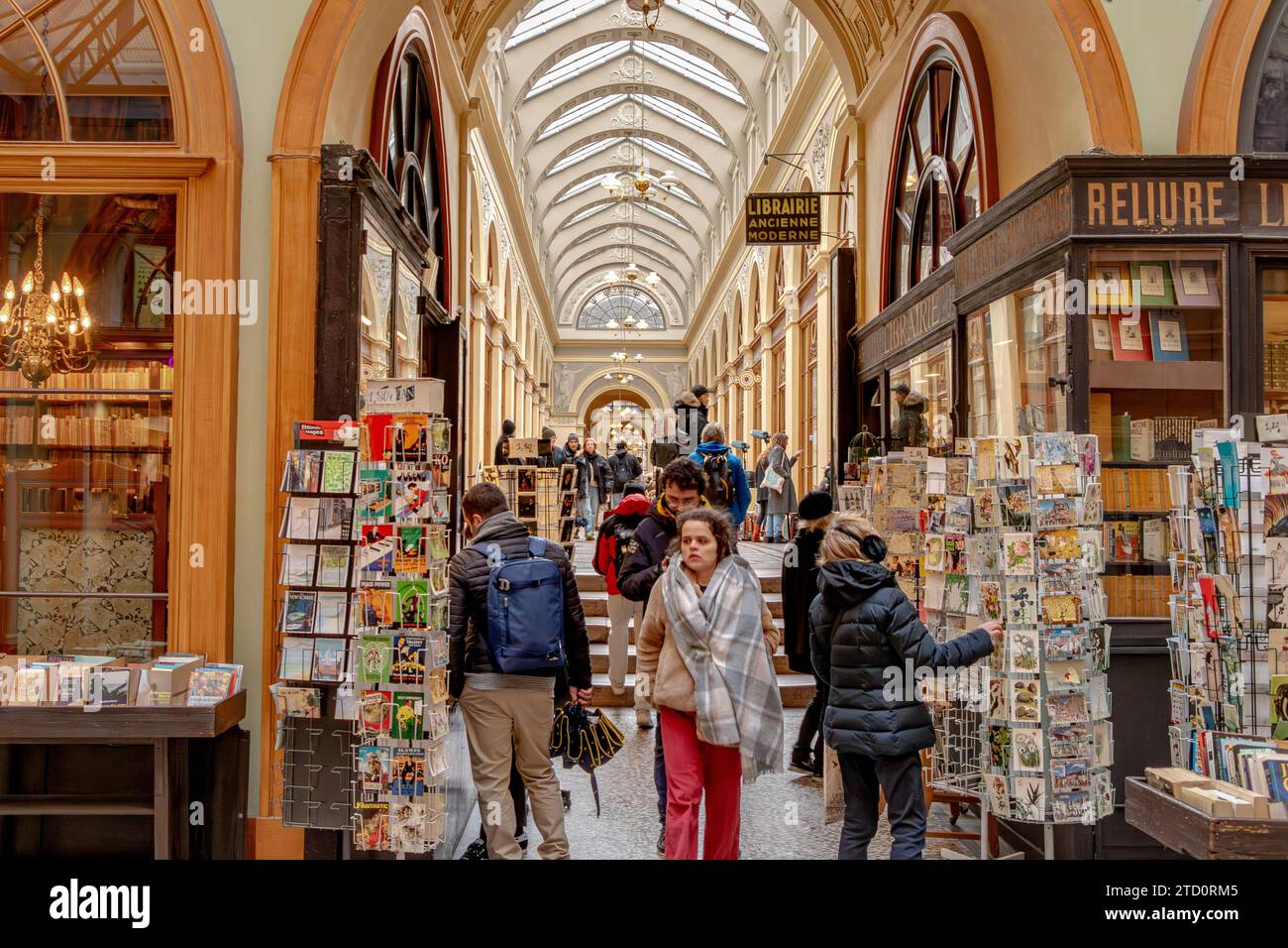 People walking through Galerie Vivienne, a beautiful covered shopping ...