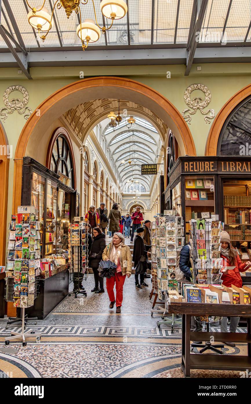 People walking through Galerie Vivienne, a beautiful covered shopping ...