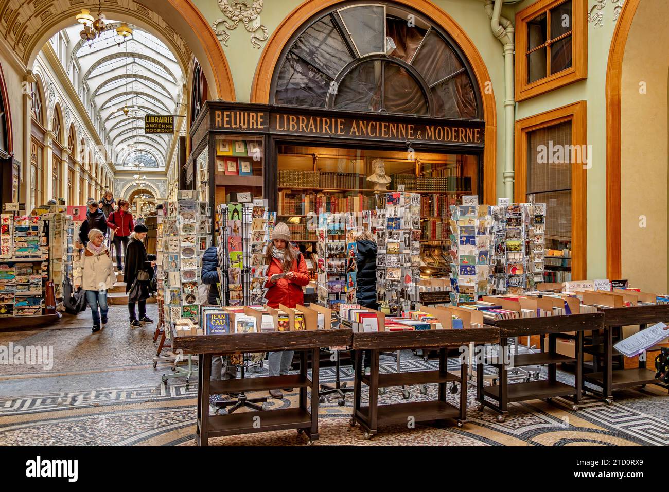 People walking through Galerie Vivienne, a beautiful covered shopping ...