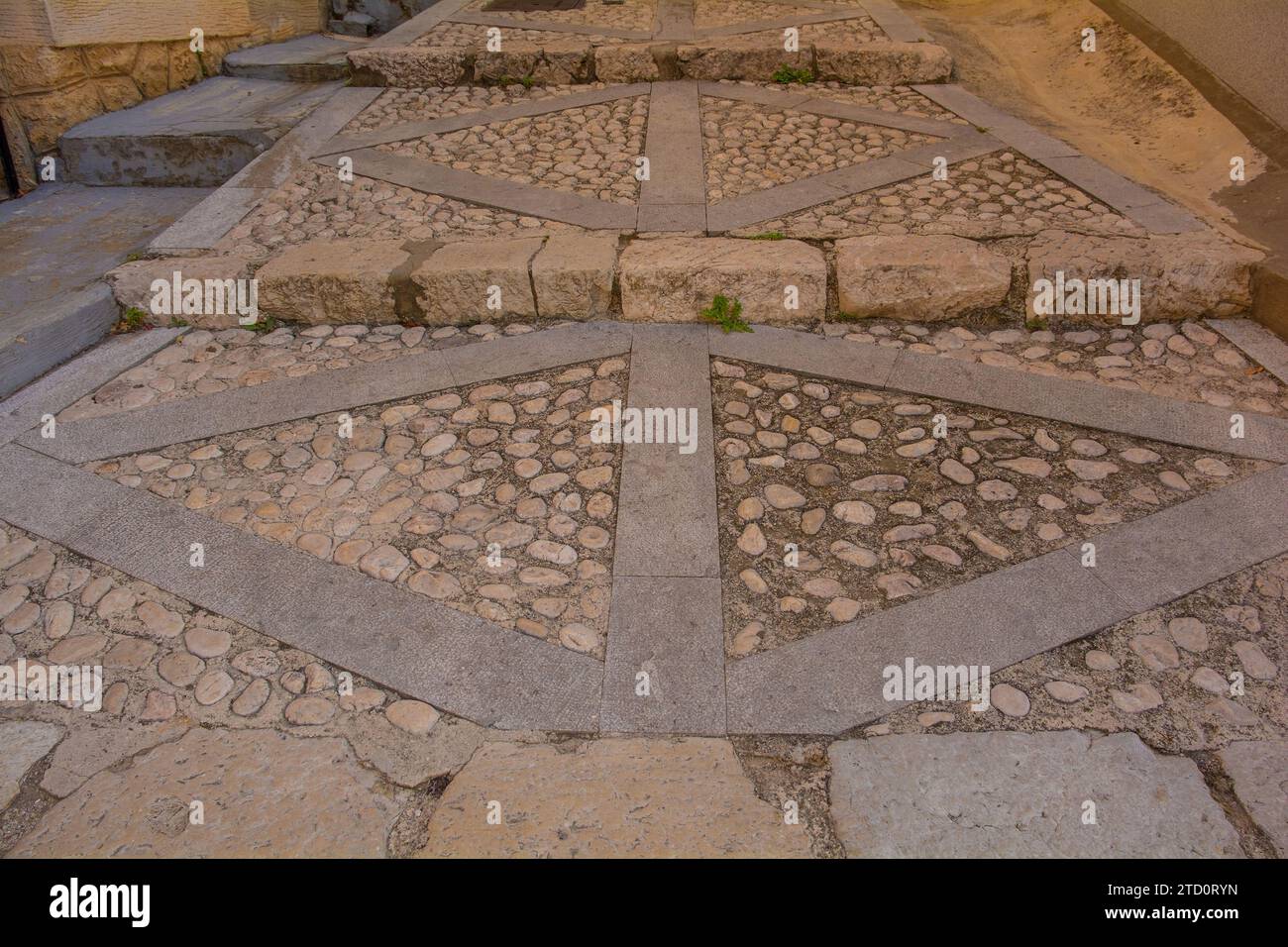 A road with traditional kogule or kogulavanje paving in the Stari Grad ...