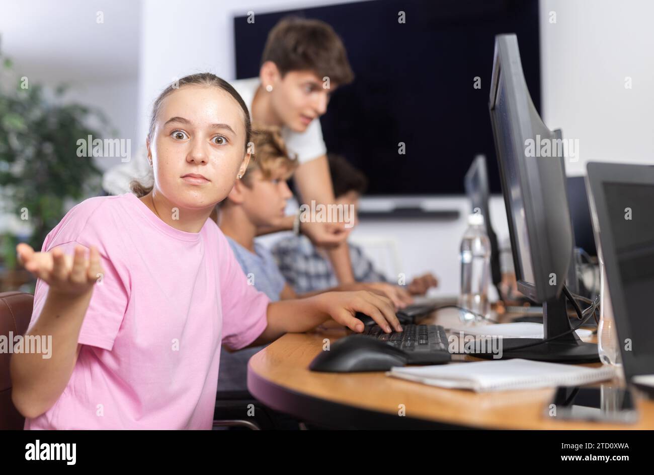 Girl student learning to work on computer in classroom Stock Photo - Alamy