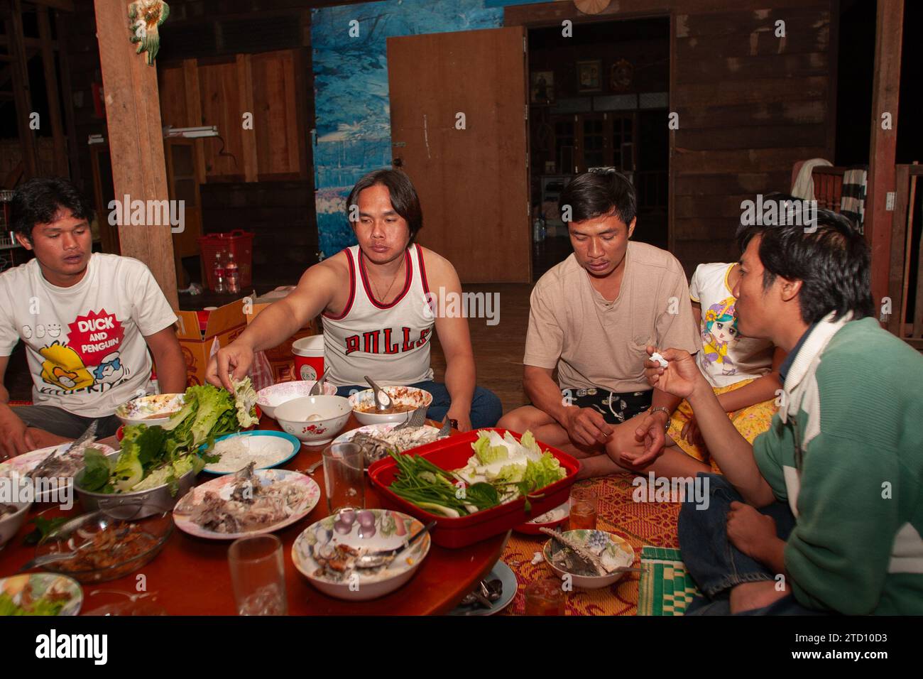 Family meal in a village in northern Thailand in the province of Isan ...