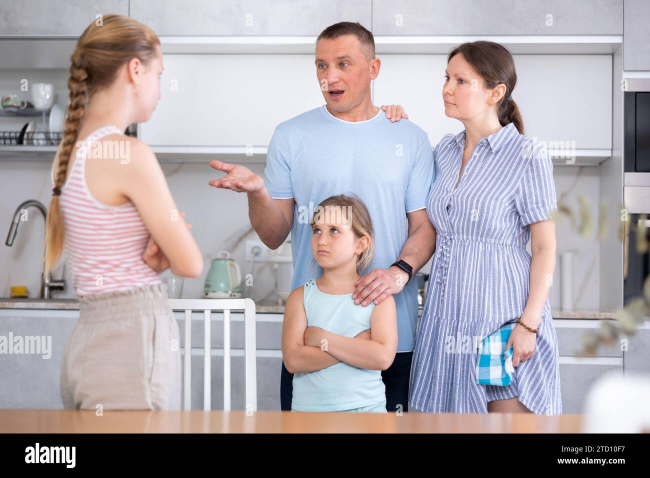 Teenage daughter with father in kitchen hi-res stock photography and ...