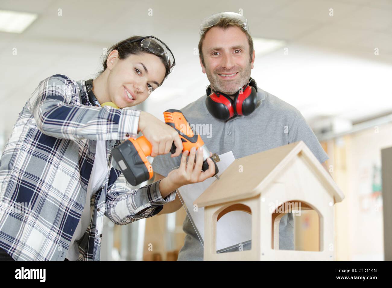 teacher explaining structure to a student in a woodwork class Stock ...