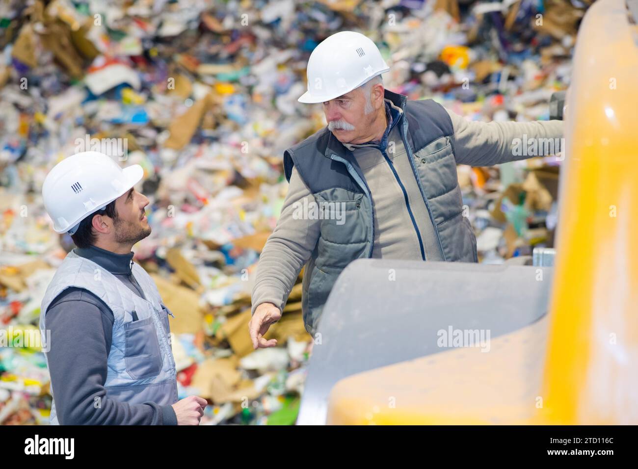 portrait of recycling factory workers conversing Stock Photo - Alamy