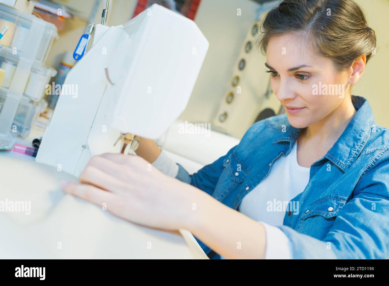 a woman using sewing machine Stock Photo - Alamy