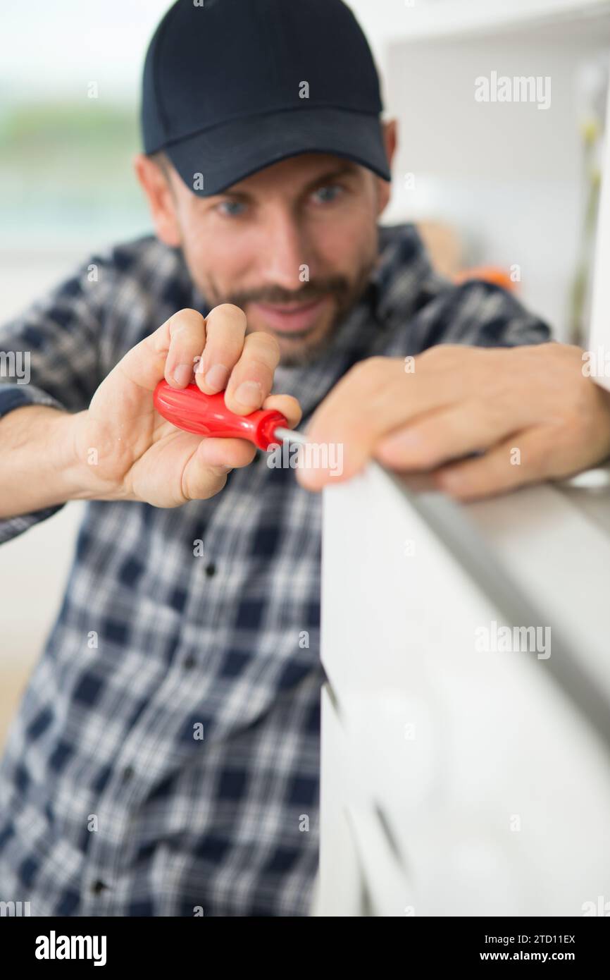 workman using screwdriver Stock Photo - Alamy