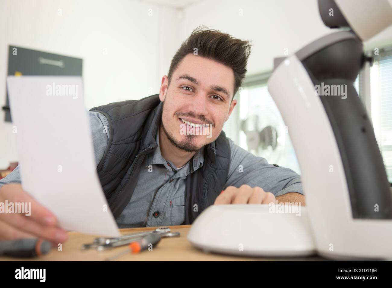 happy man repairing broken coffee machine Stock Photo - Alamy