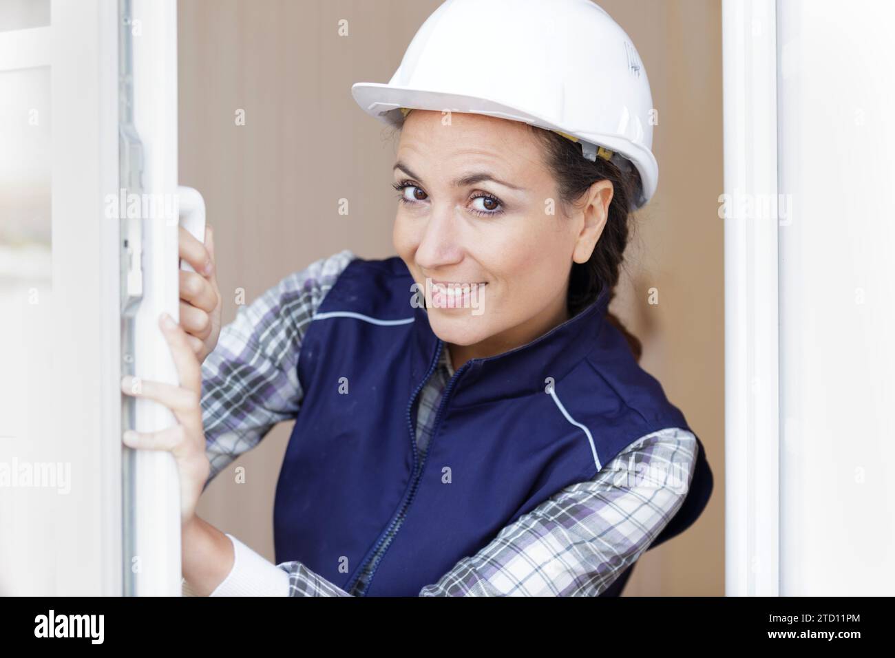 portrait of professional female builder at open window Stock Photo - Alamy