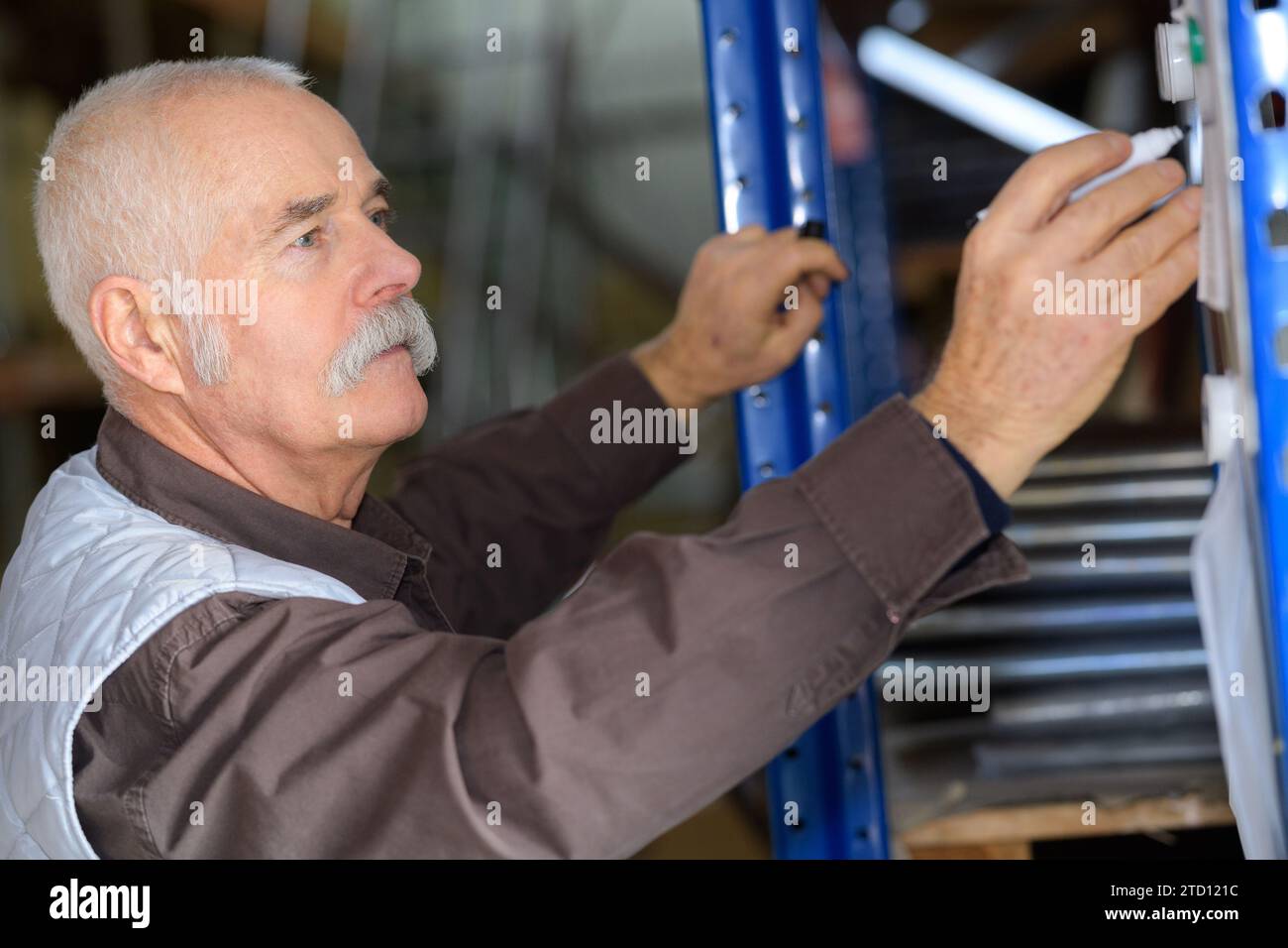 industrial worker inspecting work piece Stock Photo - Alamy