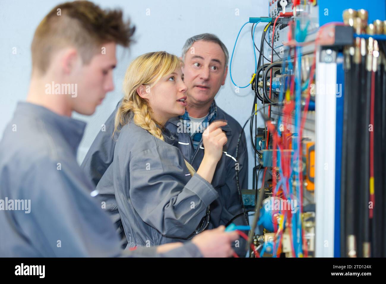 teacher observing students working on electrical circuits Stock Photo ...