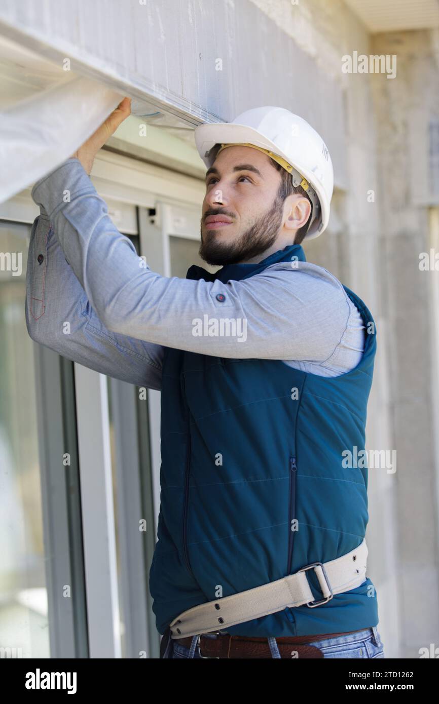 man worker installing metal sill on external pvc window frame Stock ...