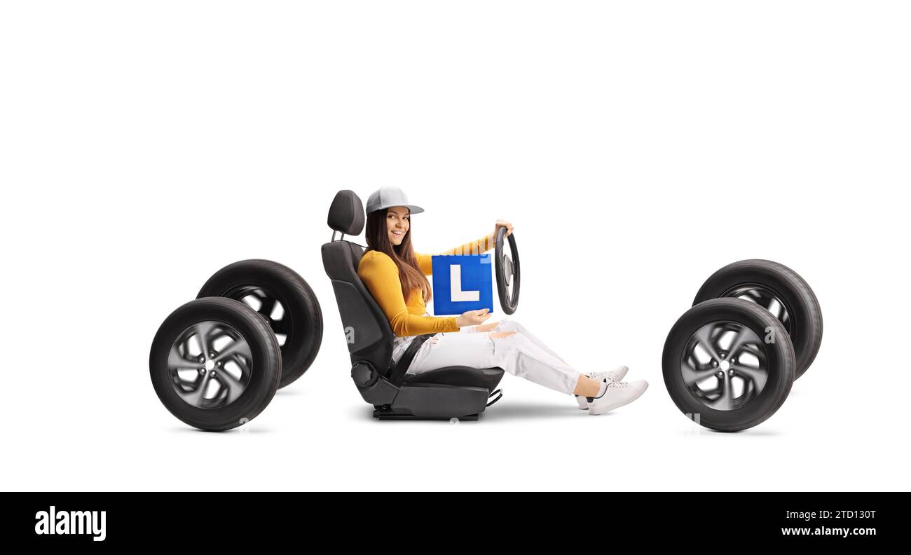 Young female driver with a learning plate holding a steering wheel ...