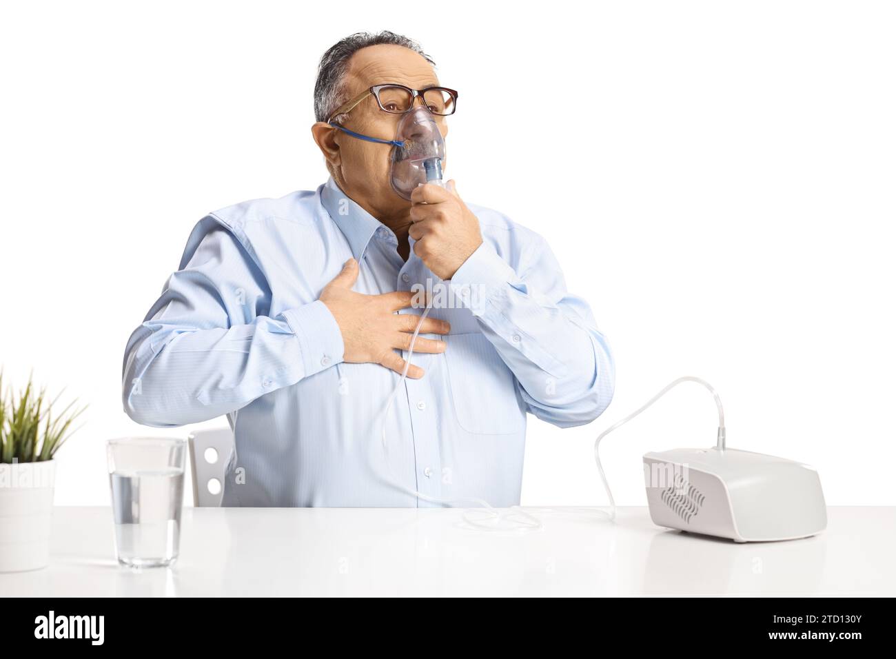 Mature man with chest problem using a nebulizer isolated on white ...