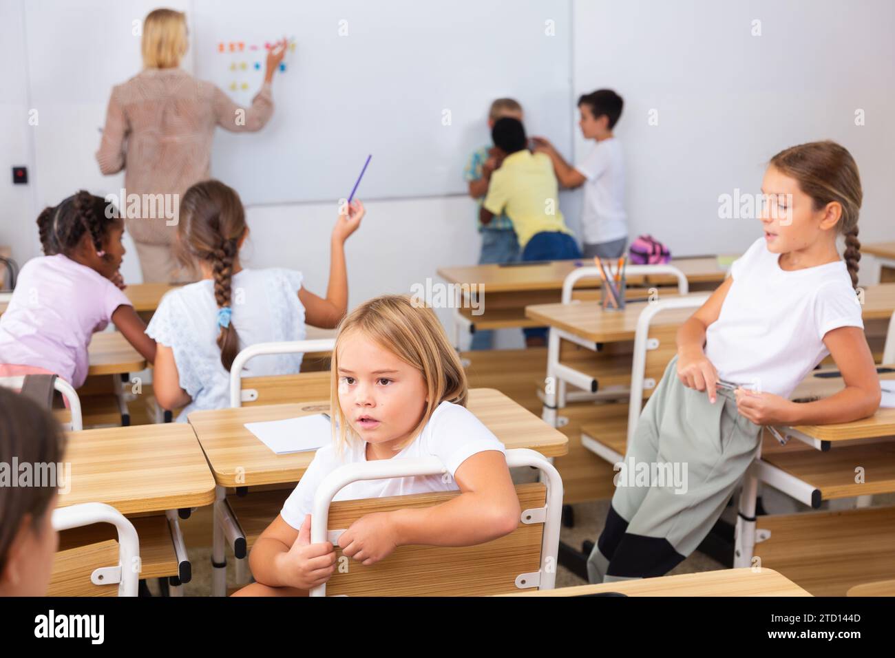 Tween boys and girls friendly talking in break in classroom Stock Photo ...