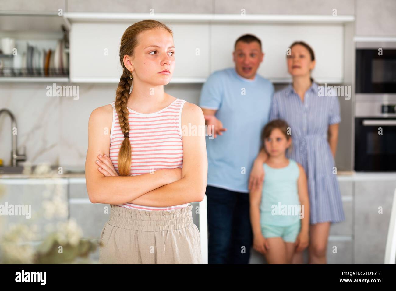 At home kitchen parents scold standing female child for bad behavior at ...