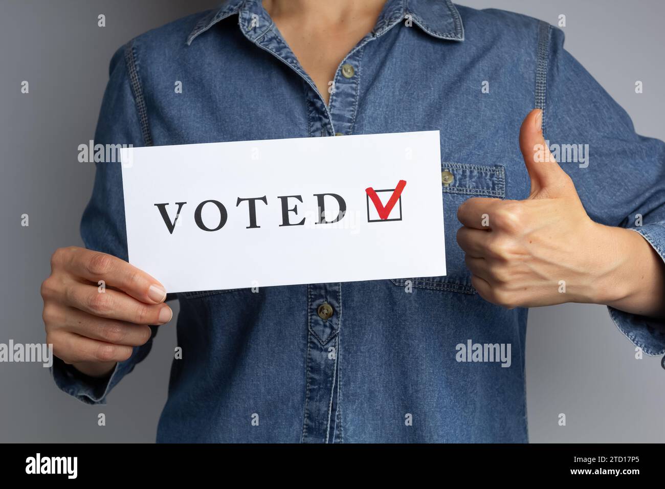 Hand puts a vote mark. Election concept Stock Photo - Alamy