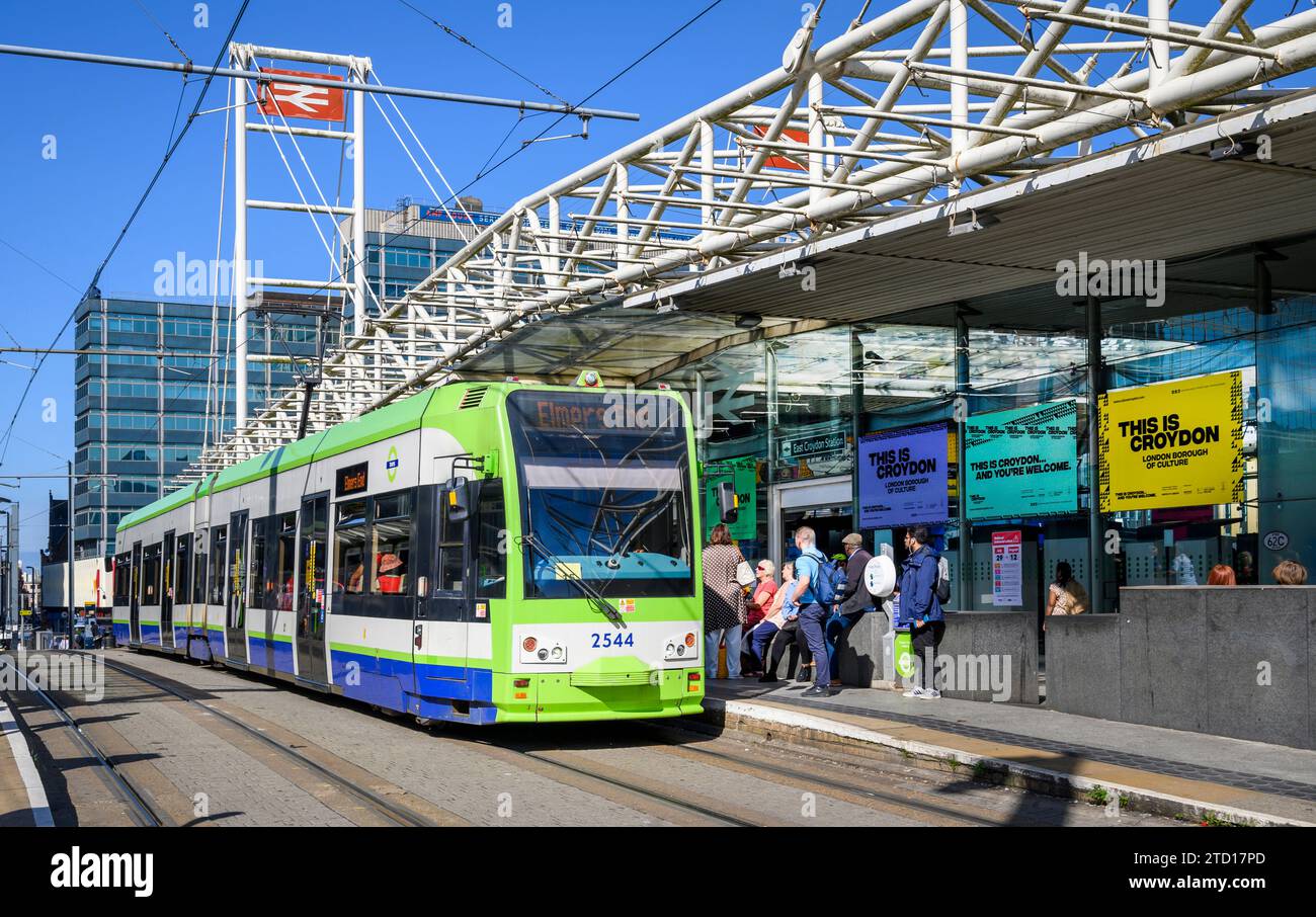 London Trams tram waiting at a stop outside East Croydon railway ...